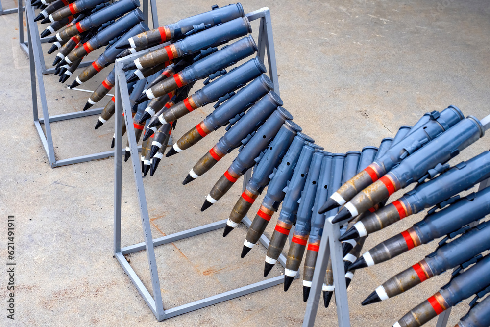 Large caliber cartridges. Shells for machine gun on metal stands ...