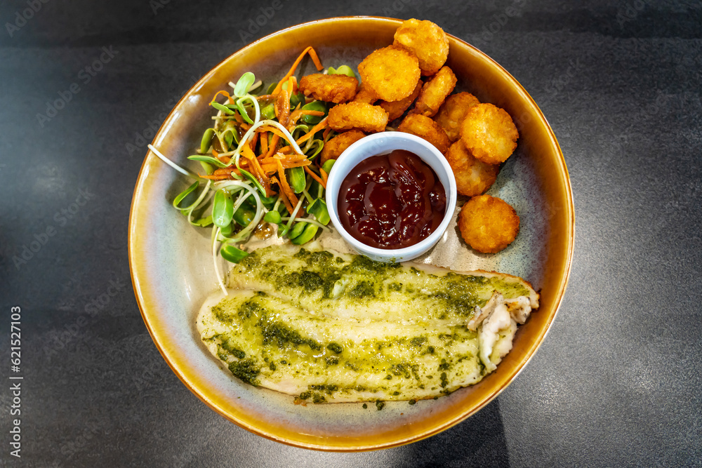 Fried fillet of sea white cod fish with chicken nuggets on a large dish ...