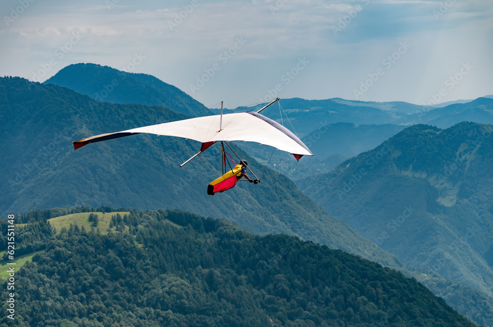 Vintage hang glider flies in the mountains Stock Photo | Adobe Stock