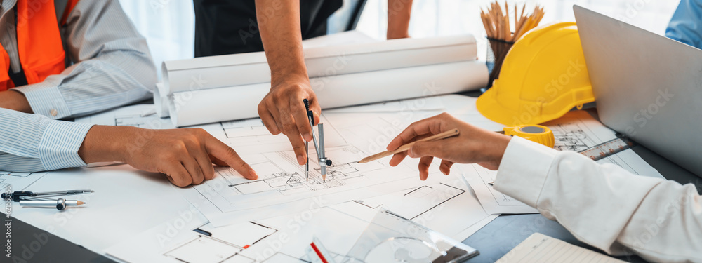 Architect or engineer working on building blueprint, contractor ...