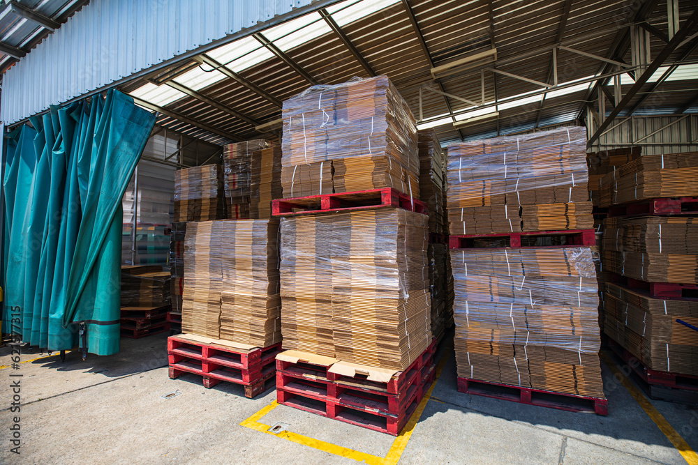 Folded cardboard boxes in the warehouse. Stack of flat industrial ...