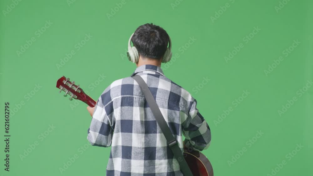 Back View Of Young Asian Teen Boy Wearing Headphone Playing Guitar And ...