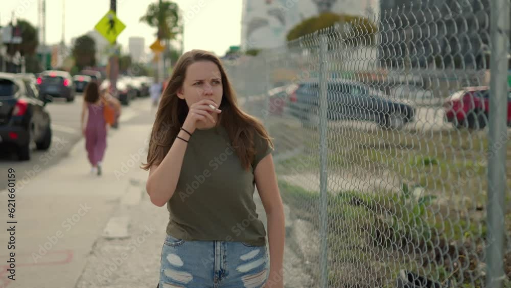 Young angry woman smoking a cigarette in extreme slow motion - Miami ...