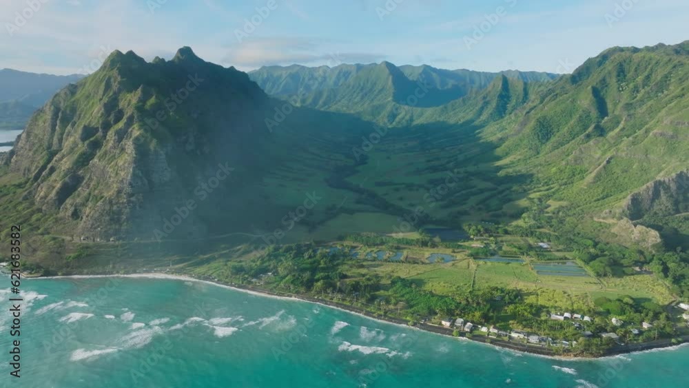 Aerial of dramatic mountains, blue ocean at Kualoa Ranch park ...