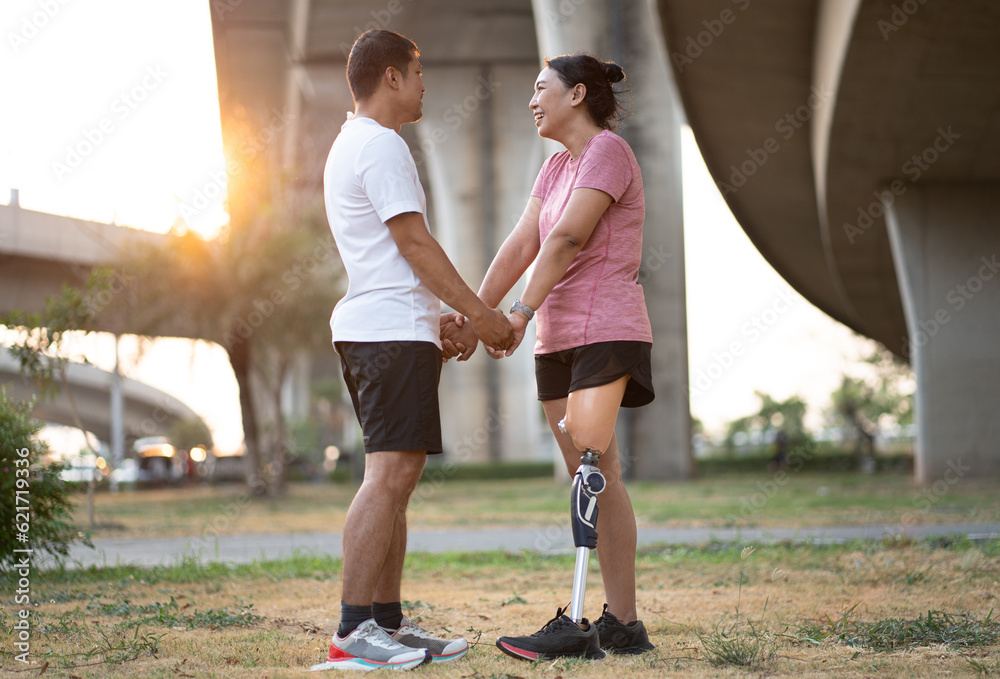 Exercise Asia woman with prosthetic leg holding hand boy friend in the ...