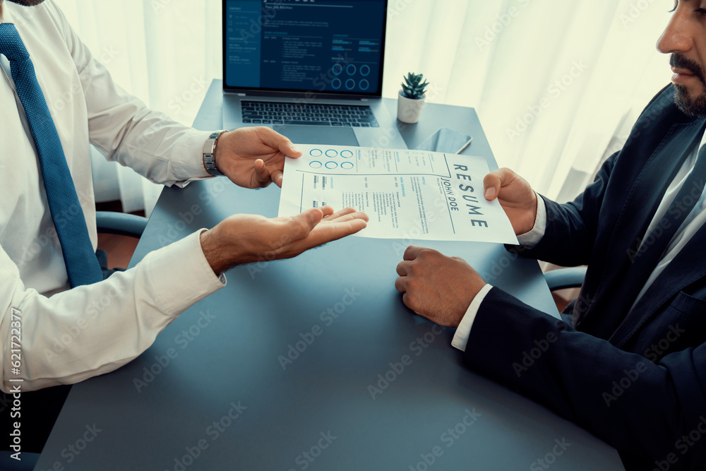 Confident man wearing suit in formal office, hand holding resume paper ...