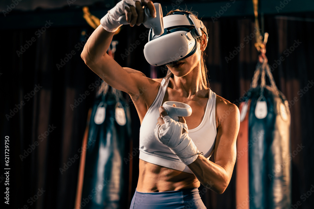 Female boxer training with VR or virtual reality, wearing VR headset ...