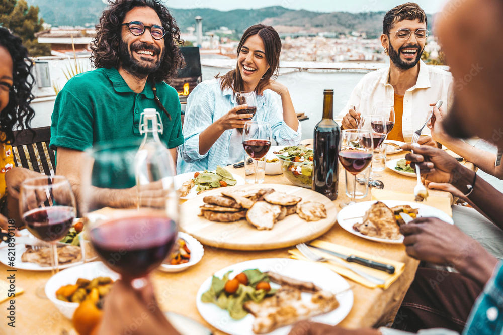 Multiethnic friends having fun at rooftop bbq dinner party - Group of ...