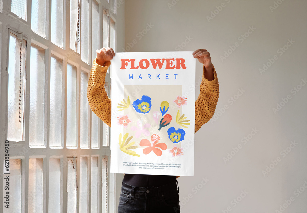 Mockup of woman holding customizable A2 poster in front of face Stock ...