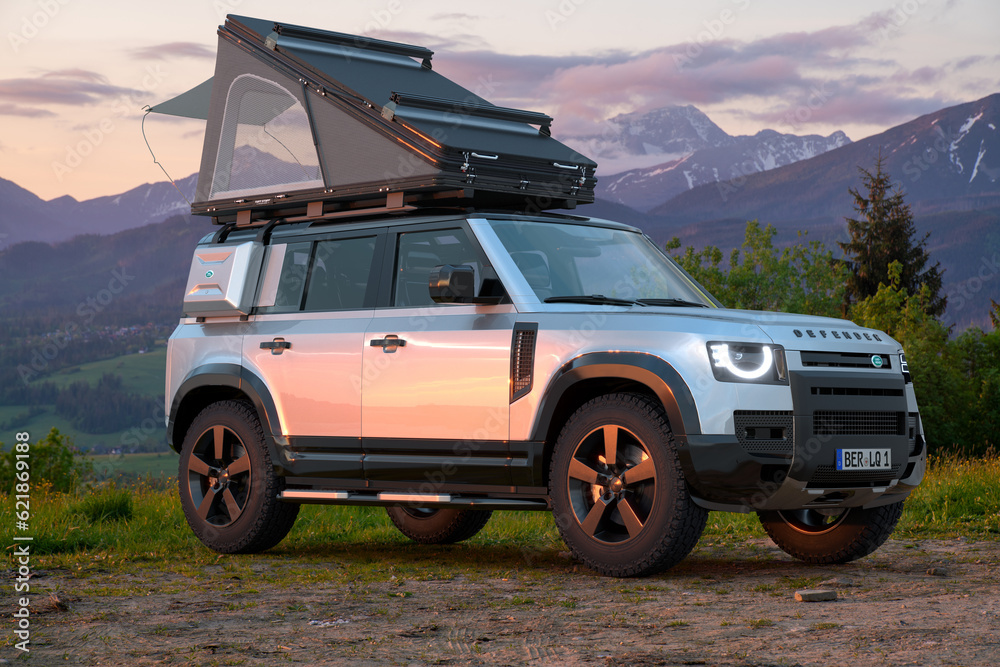 Land Rover Defender in wild terrain, equipped with expedition gear and ...