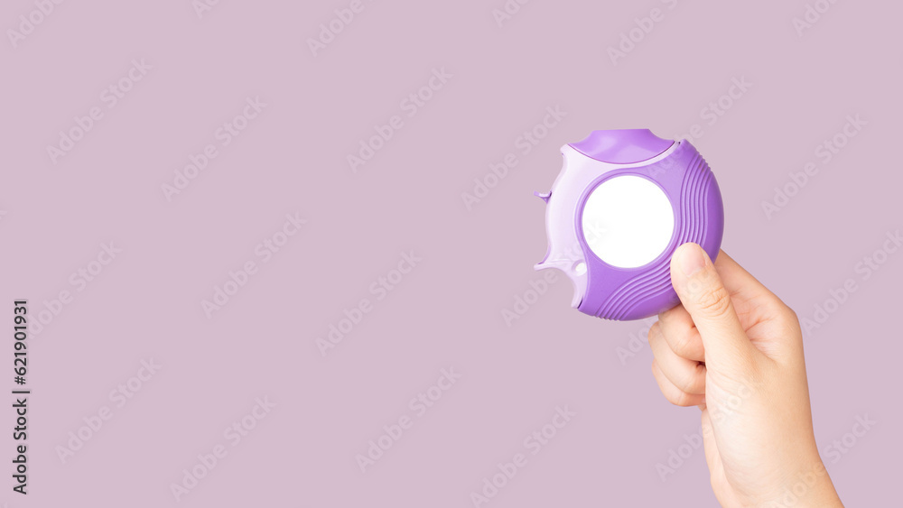 Asthma and COPD concept. Hand holding medicine dry powder inhaler on ...