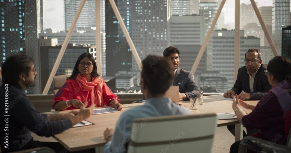 Young Indian Businessman Leading a Conversation with a Talented Team of ...