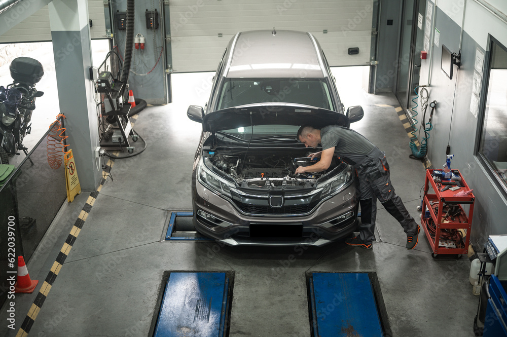 car mechanic changing car engine Stock Photo | Adobe Stock