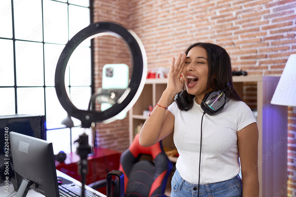 Young arab woman influencer recording herself with smartphone clueless ...