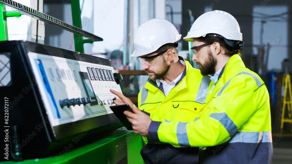 Caucasian male worker of plant in helmet and yellow uniform working at ...