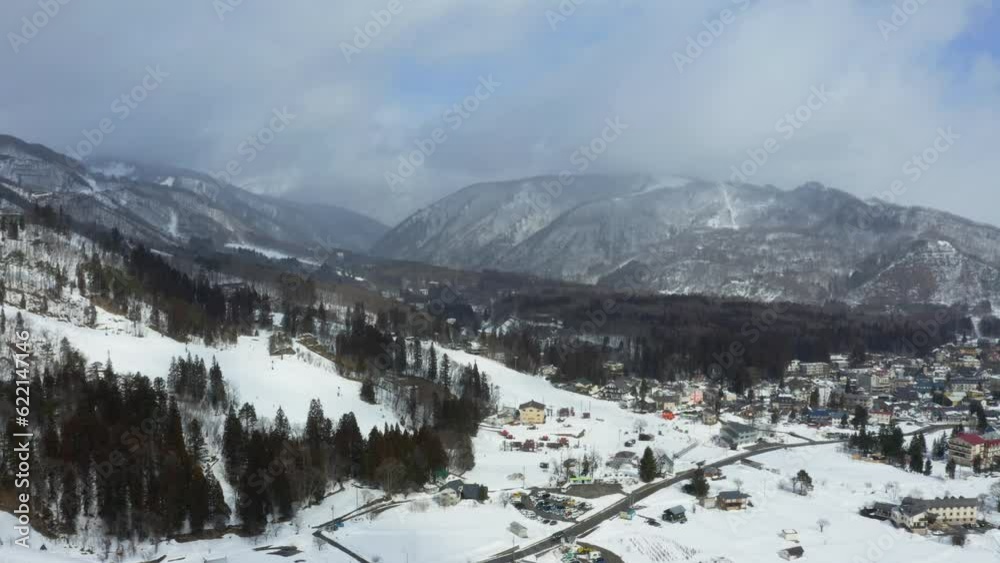 The drone gracefully captures a mesmerizing aerial view of Hakuba ...