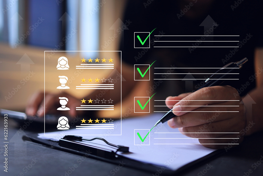 A businessman write green check mark to online evaluating a vendor or ...