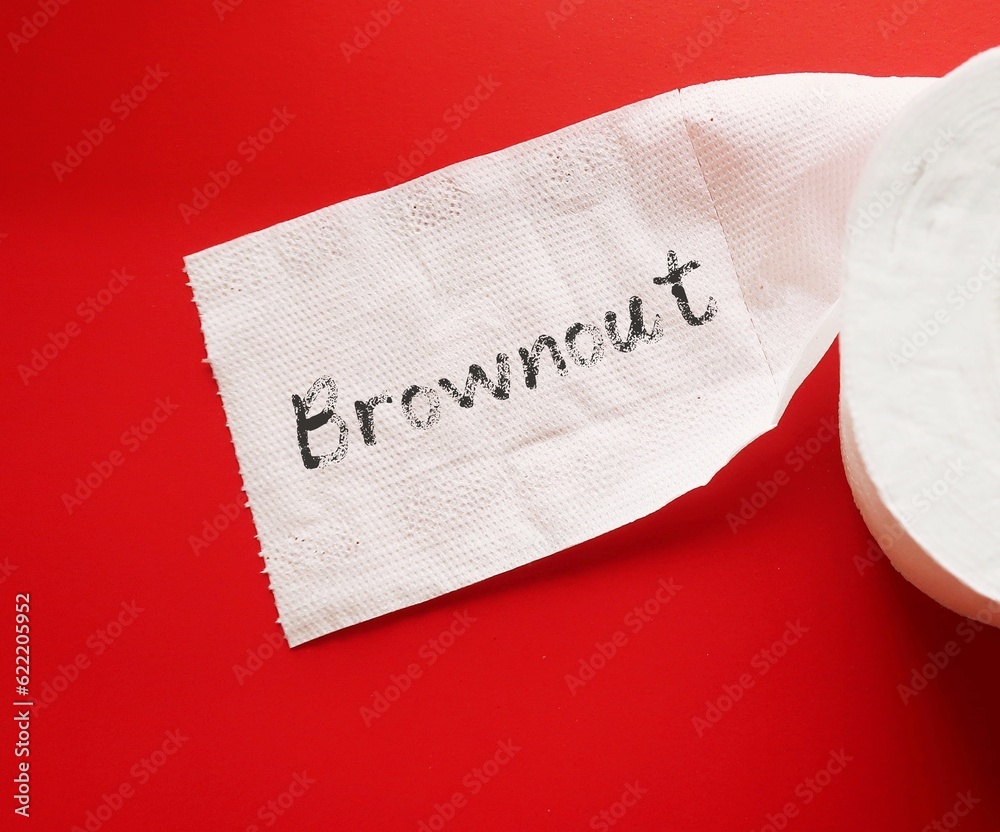 Toilet paper on red background with handwritten word BROWNOUT ...