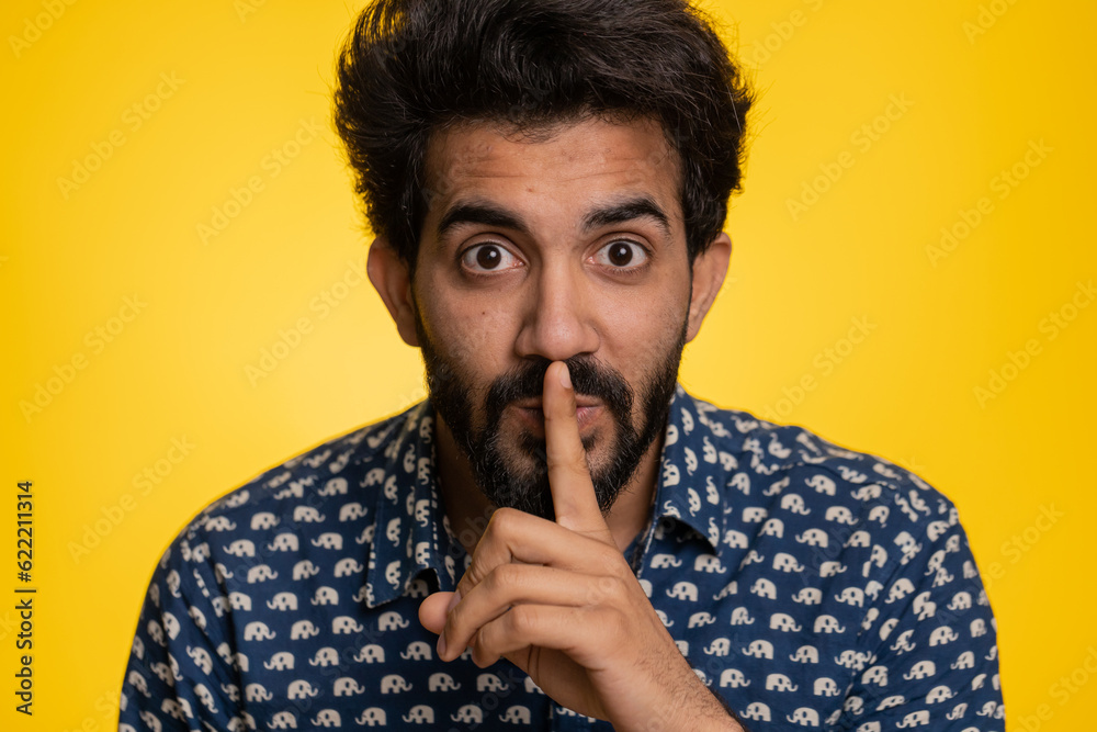 Shh be quiet please. Young indian man presses index finger to lips ...