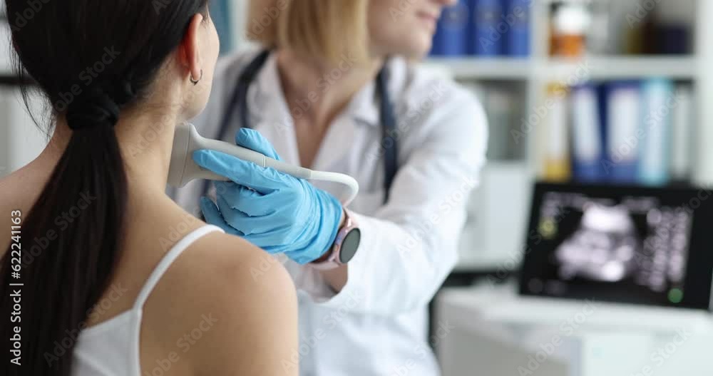 Doctor with a probe on a woman's neck, close-up. Ultrasound of lymph ...