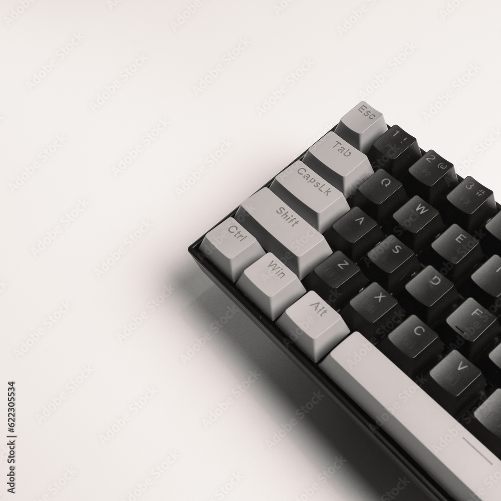 mechanical keyboard with black gray and orange keycaps on a minimalist ...