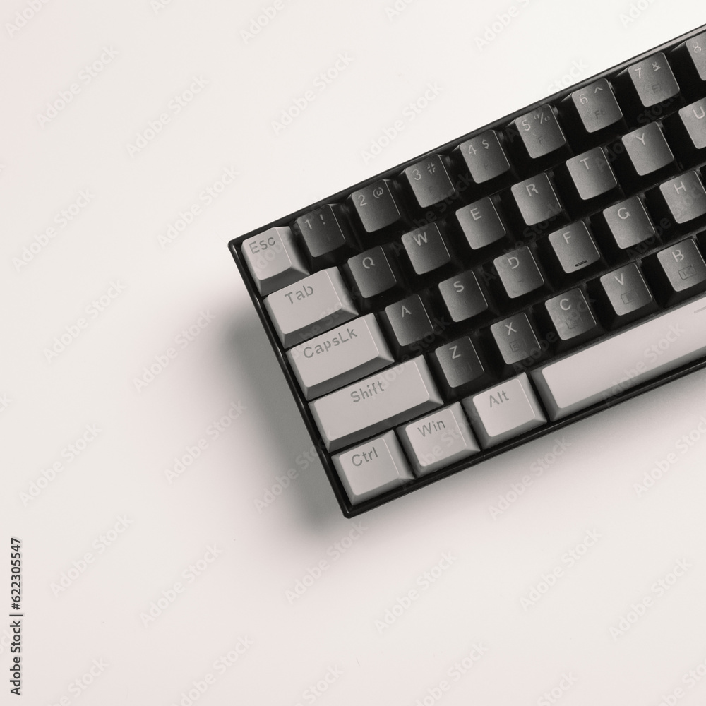 mechanical keyboard with black gray and orange keycaps on a minimalist ...