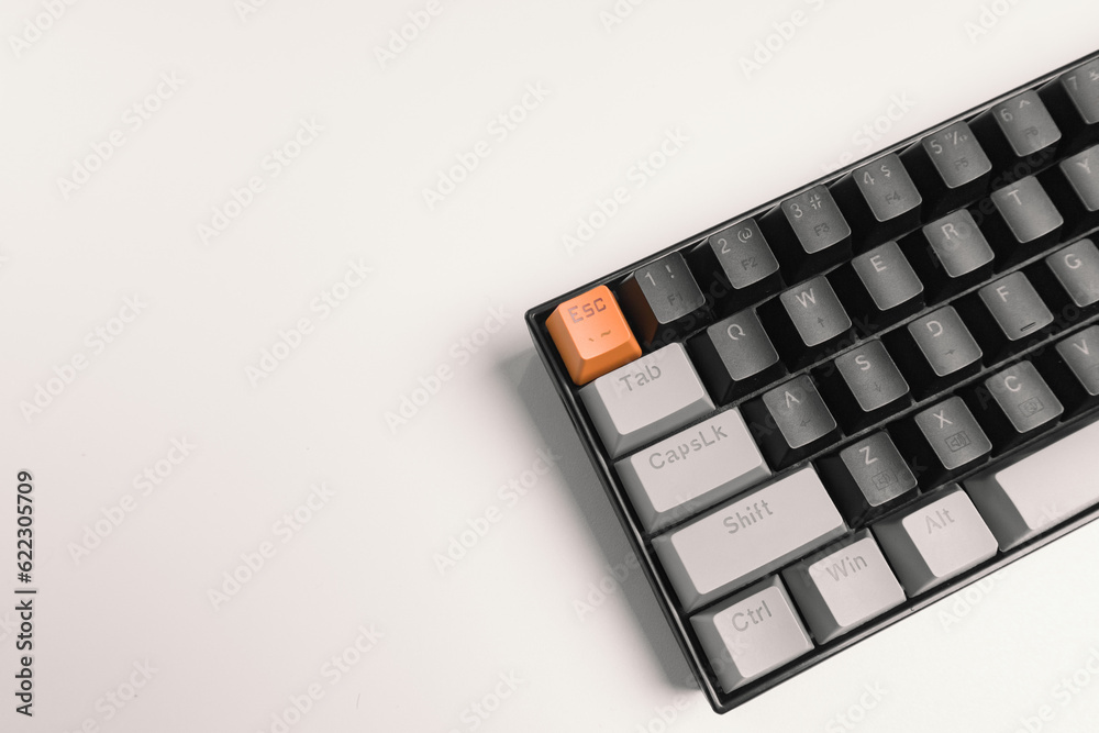 mechanical keyboard with black gray and orange keycaps on a minimalist ...