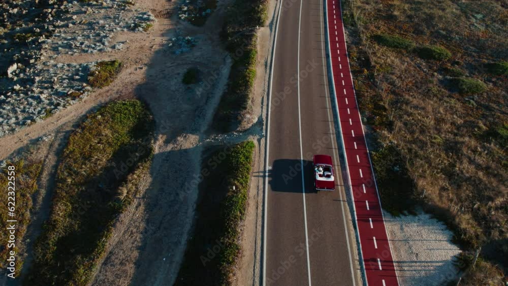 Drone camera follows vintage luxurious red convertible. Cabriolet old ...