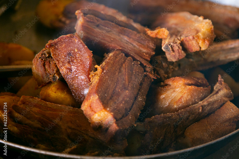 Pork chicharrón is a traditional food in Peru. Pork fat is used to cook ...