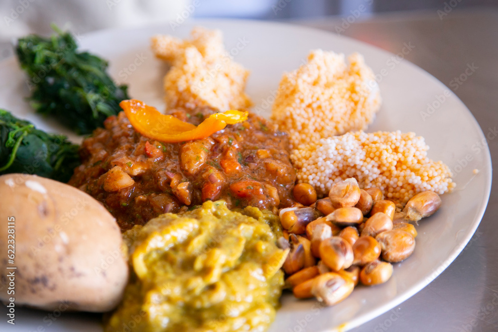 Loritos de chicha con cau cau y ceviche. Traditional combined dish from ...