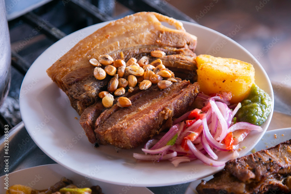 Pork chicharrón is a traditional food in Peru. Pork fat is used to cook ...