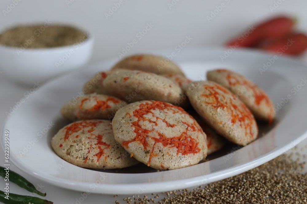 Carrot bajra idly. Steamed savory rice cake made by a batter of ...