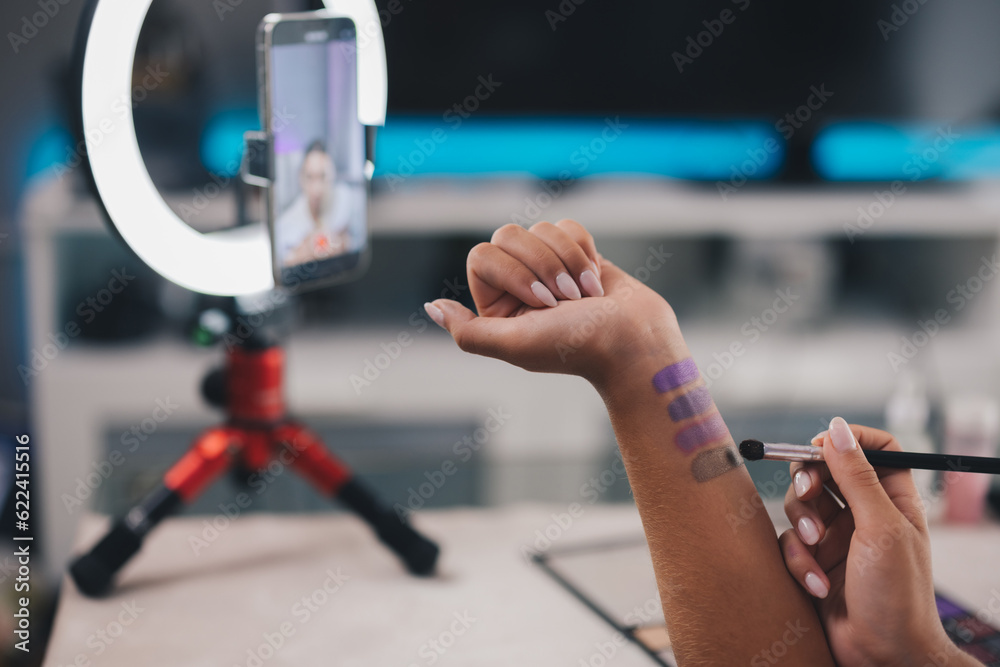 unrecognized woman influencer applying makeup at home. woman vlogger ...