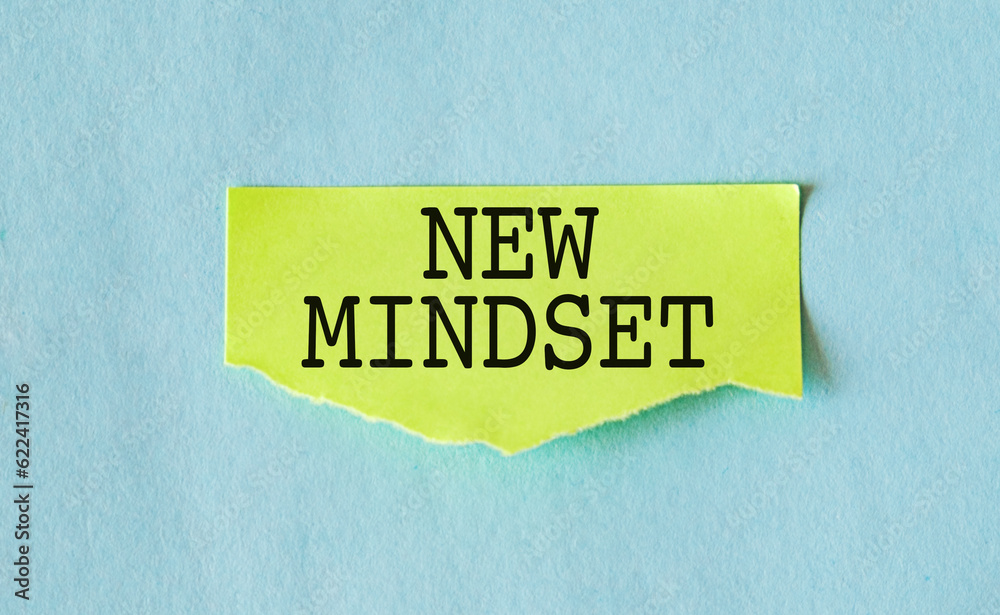 New mindset words letter, written on piece of memo paper, work desk top ...