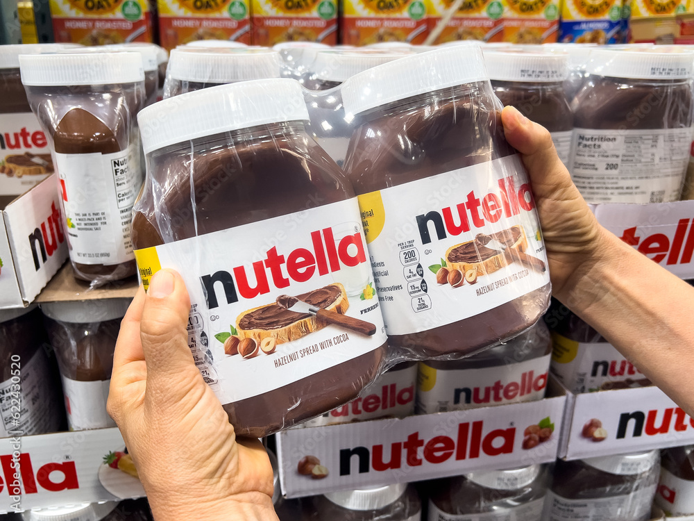 Sacramento, CA, USA July 10th, 2023 Customer hands holding a two jars ...