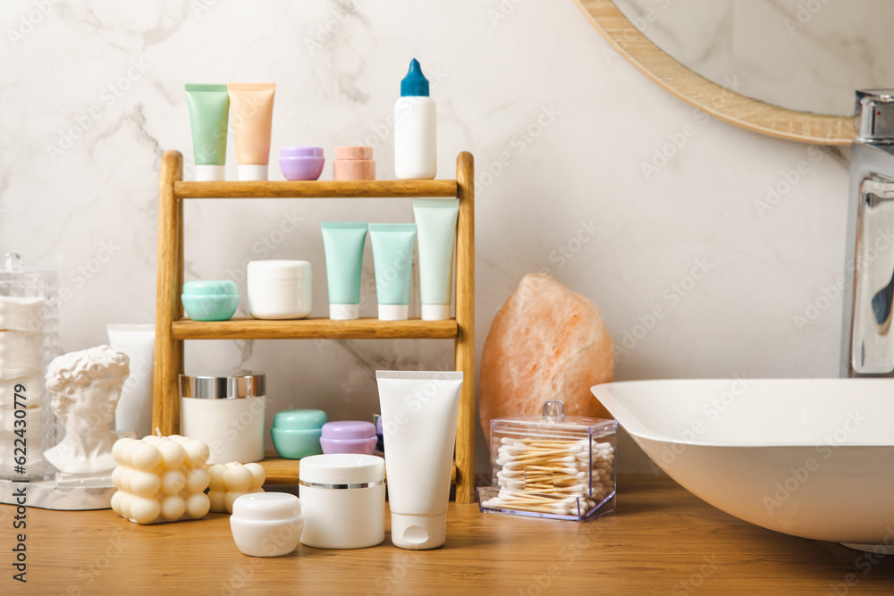 Care cosmetics on the shelf in the bathroom. Cosmetic tube. Cleanser ...