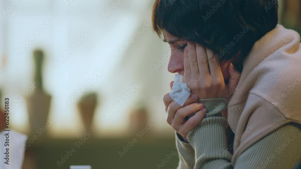 At the kitchen island in front of the camera lady have a flu she ...