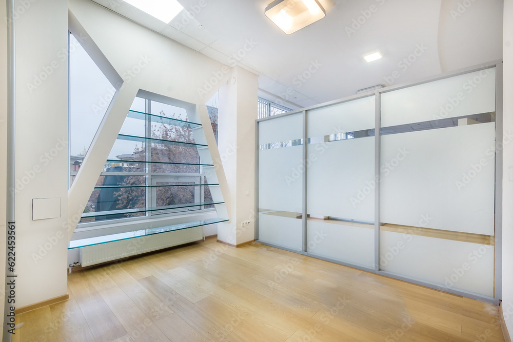 Stylish design of a modern office. Shelving with glass shelves at the ...