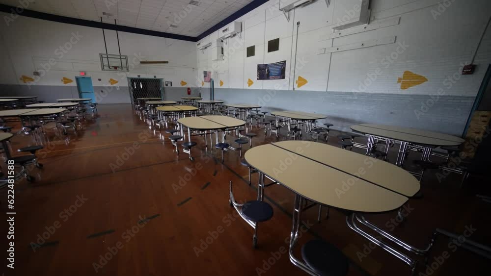 Trucking view to left showing dark and empty school cafeteria with ...