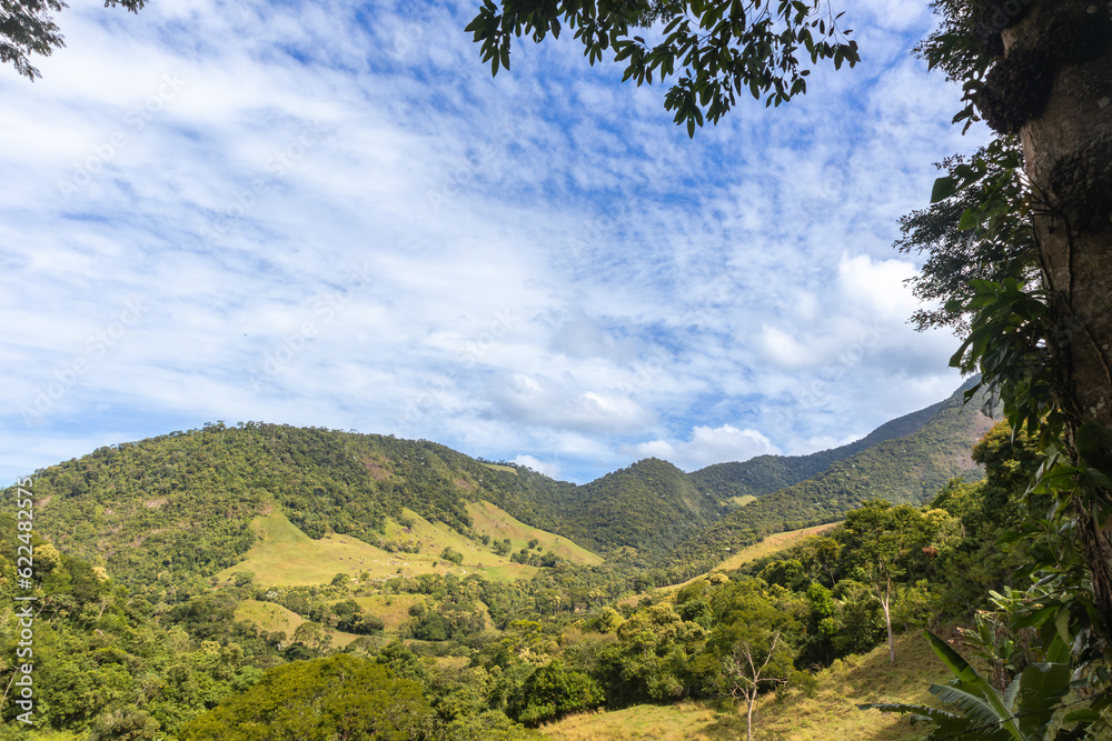 Panorama of mountainous terrain with forest and small houses. Panoramic ...