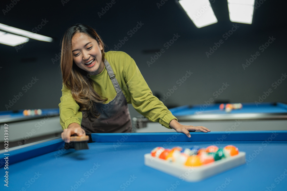 beautiful bar worker smiling while standing crossing hands on the pool ...