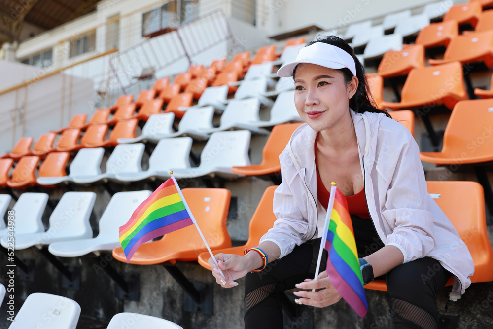 Happy and excited young female asian transgender LGBT sport fan ...