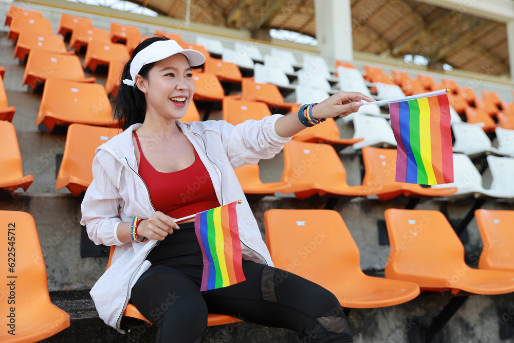 Happy and excited young female asian transgender LGBT sport fan ...