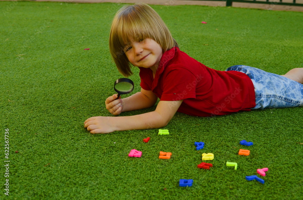 Hebrew alphabet. The boy is learning Hebrew. Multi-colored letters on ...