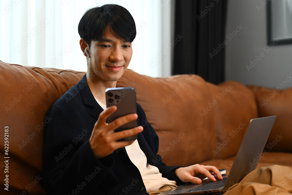 Stratified young man chatting online, typing text message on smart ...