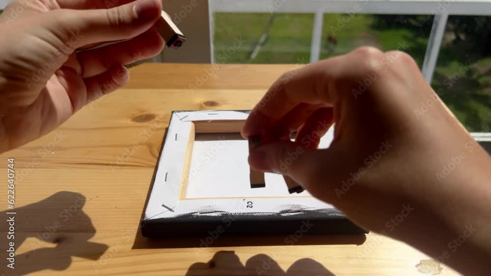 Signing canvas with ink stamps for memory. Finishing art process. POV ...