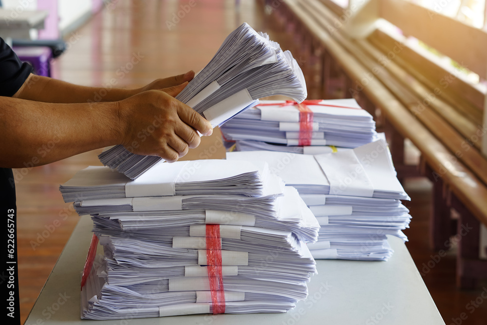 Closeup hands hold stack of used paper, combine to use next time or ...