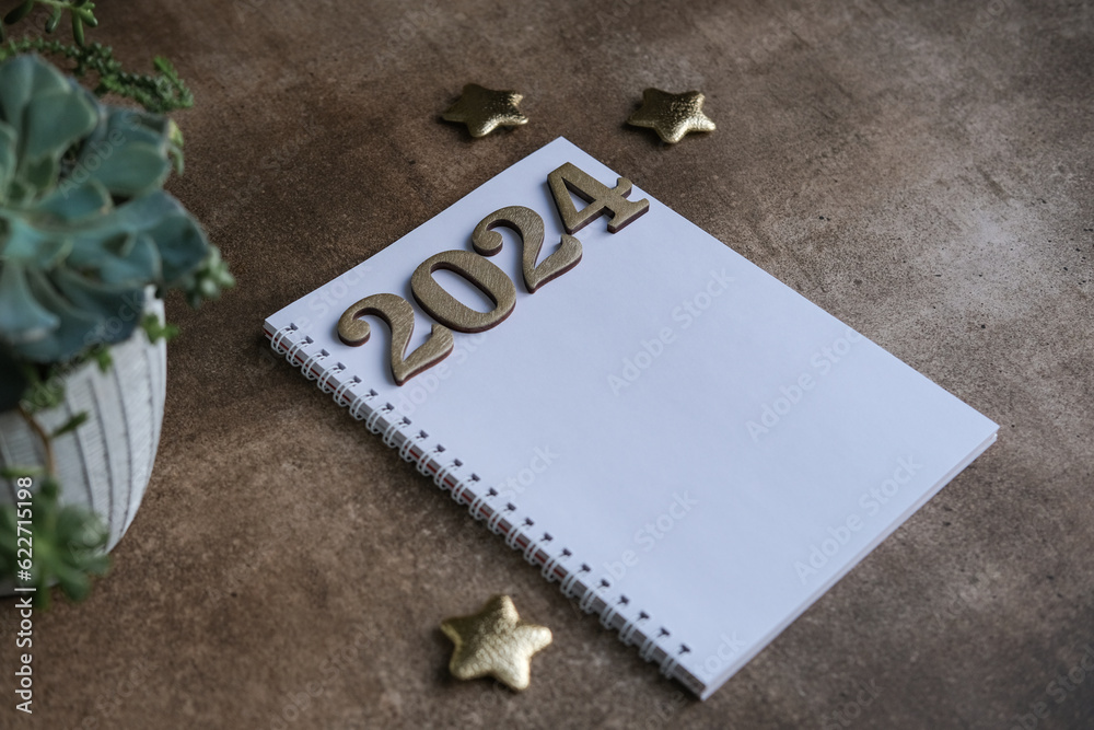 Blank notepad mockup and 2024 gold colored numbers. Wish list and goals ...