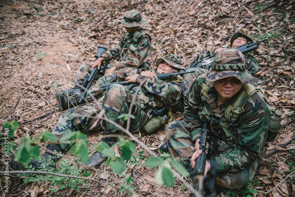 Team of army soldier with machine gun moving in the forest,Thai militia ...