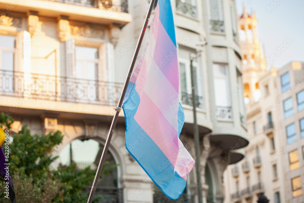 Transgender flag at pride parade in front of buildings in Valencia ...